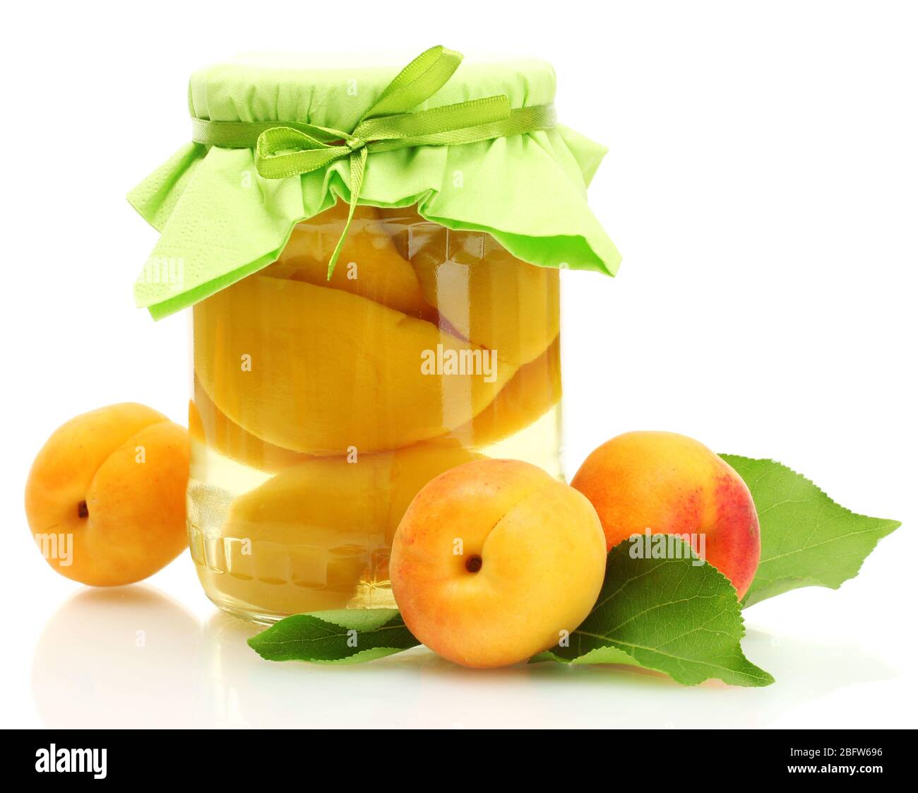 canned apricots in a jar and sweet apricots isolated on white Stock ...