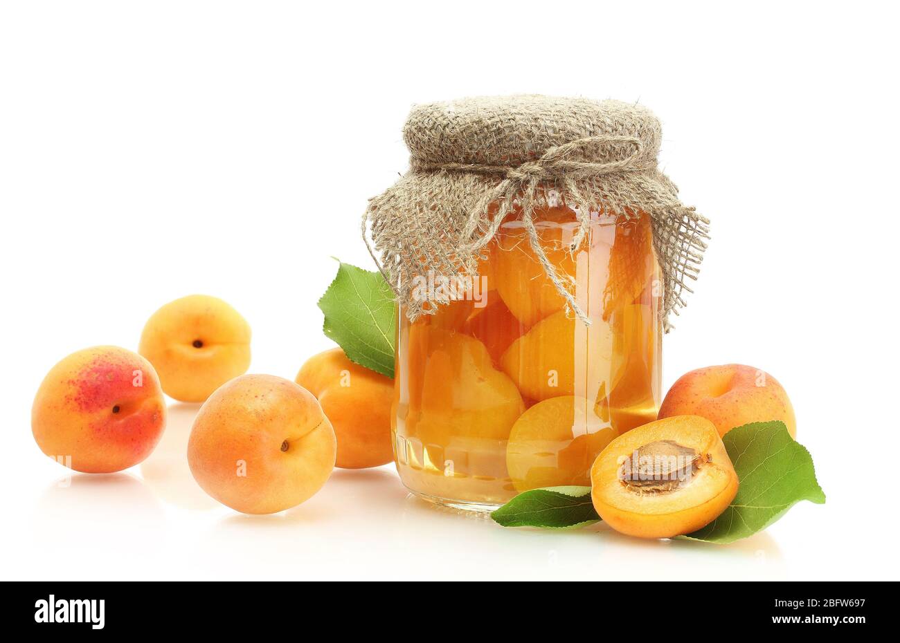 canned apricots in a jar and sweet apricots isolated on white Stock ...