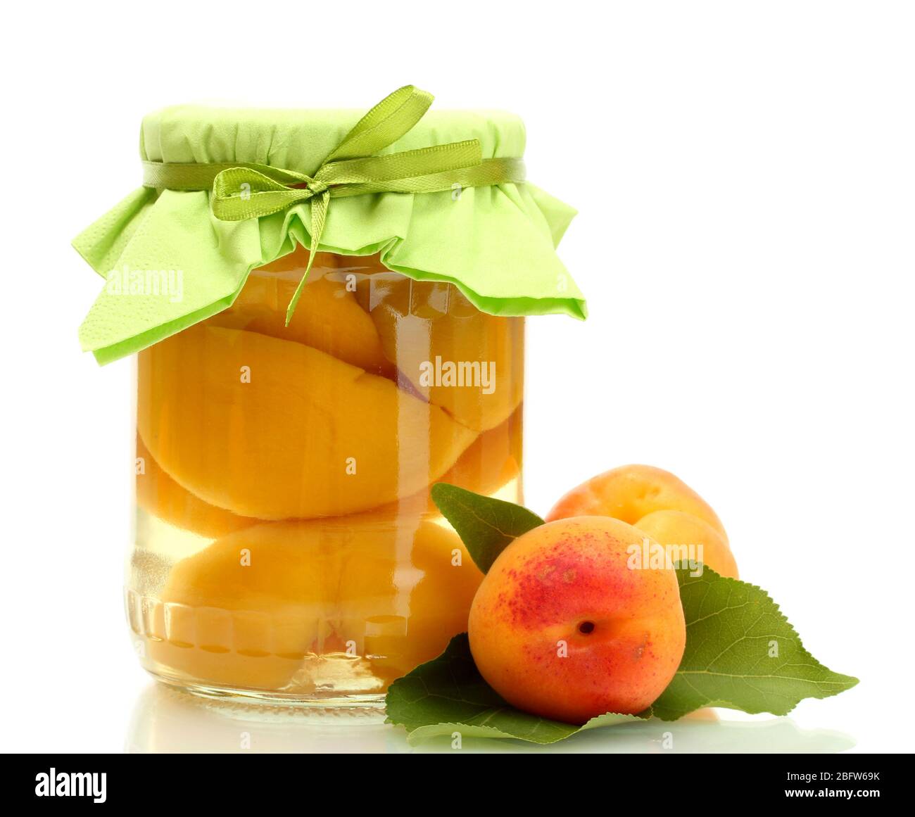 canned apricots in a jar and sweet apricots isolated on white Stock ...