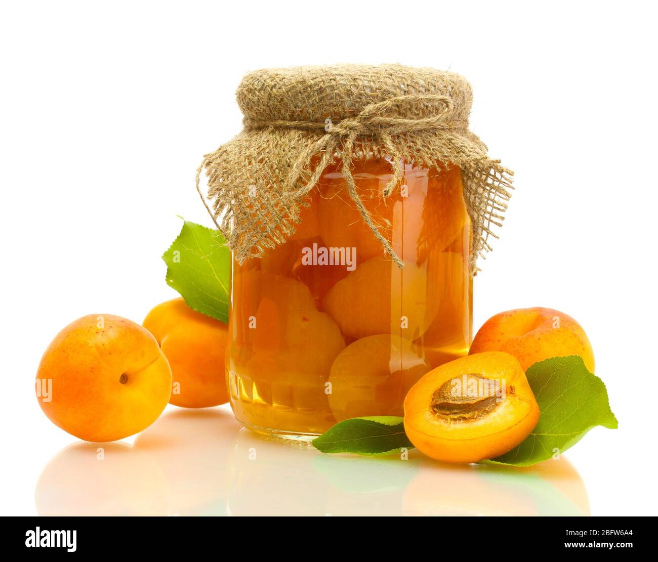 canned apricots in a jar and sweet apricots isolated on white Stock ...