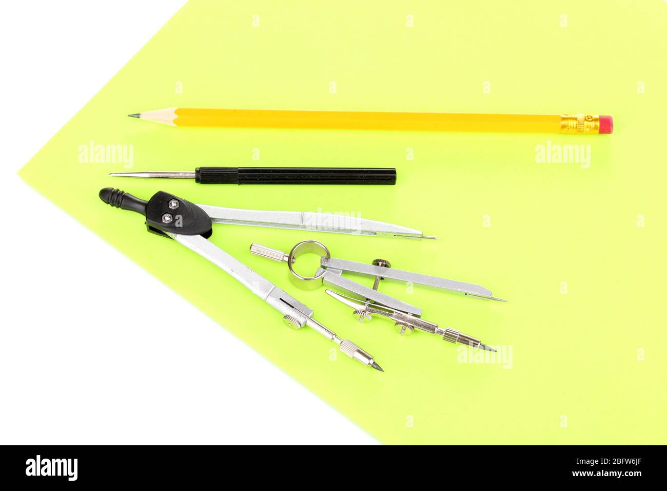 Drafting instruments on color paper isolated on white Stock Photo - Alamy