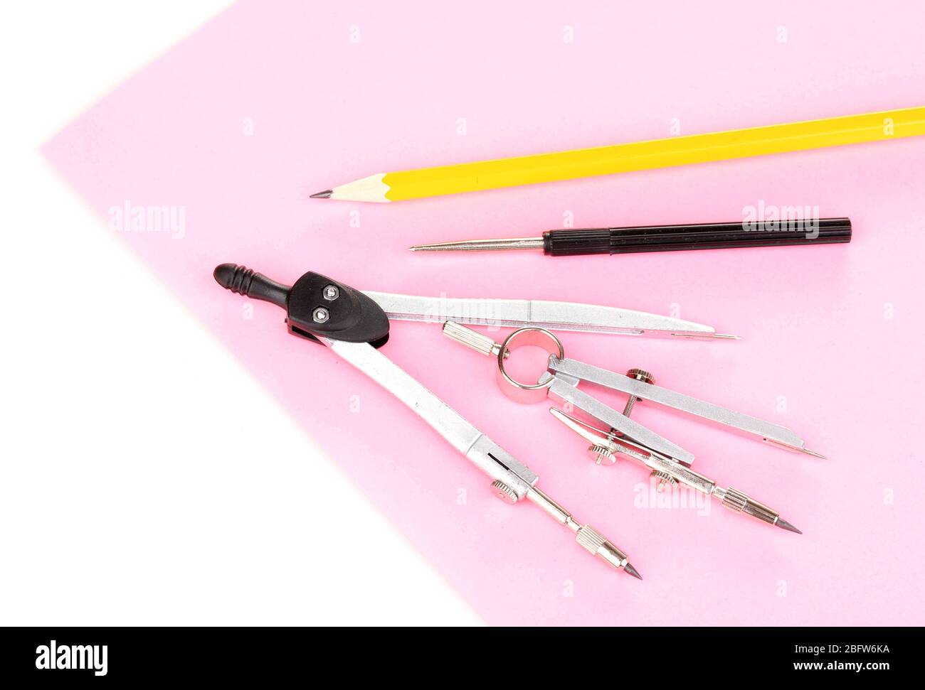 Drafting instruments on color paper isolated on white Stock Photo - Alamy