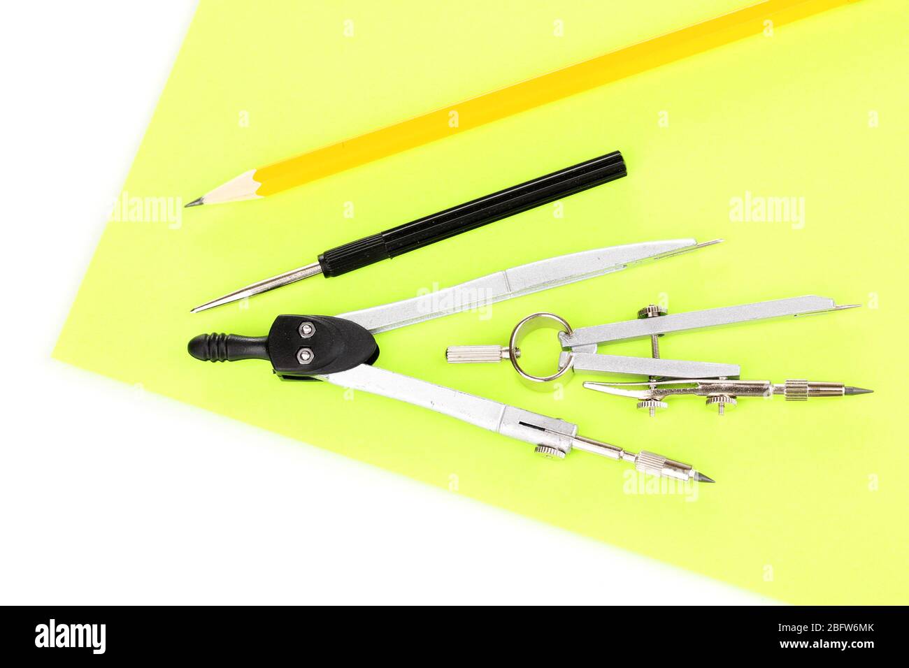 Drafting instruments on color paper isolated on white Stock Photo - Alamy