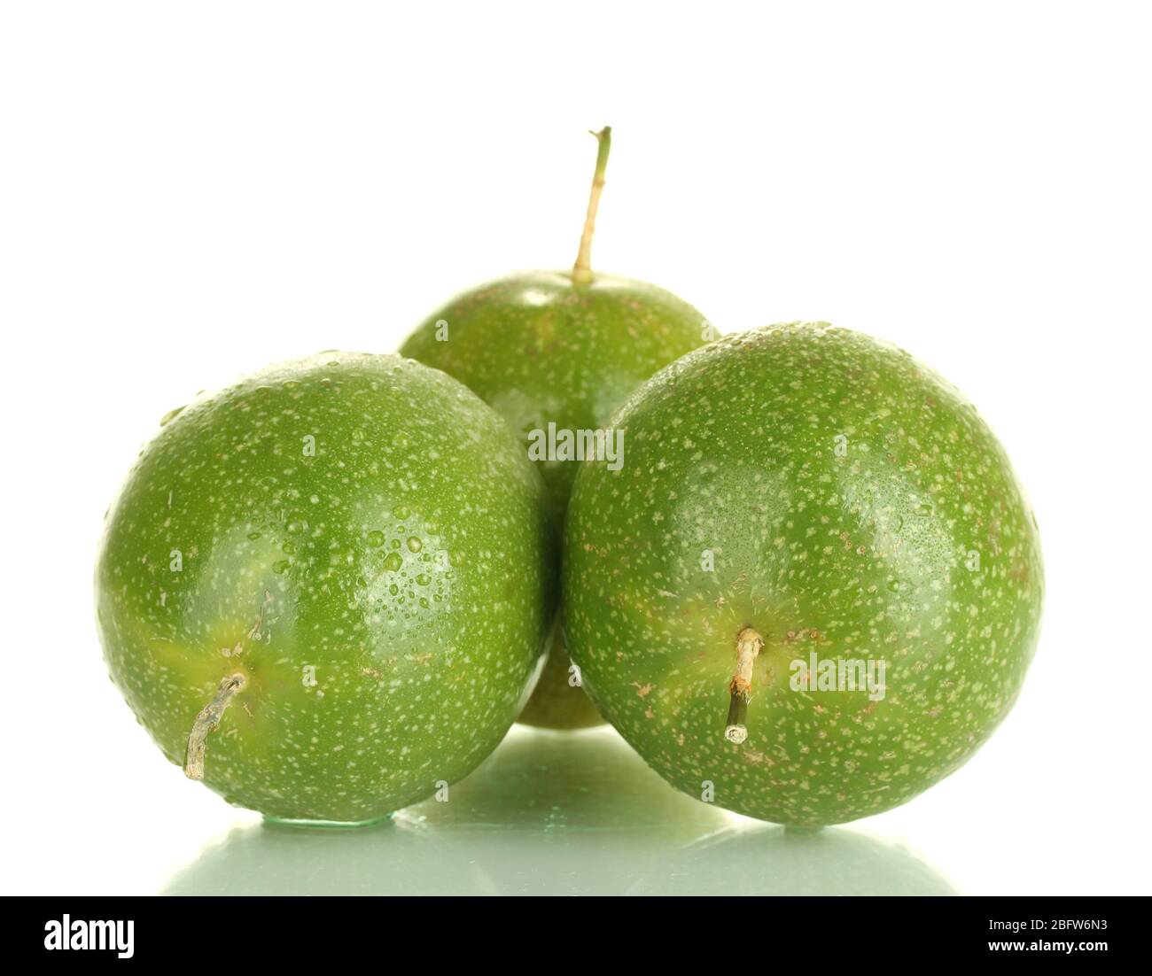three green passion fruit isolated on white Stock Photo - Alamy