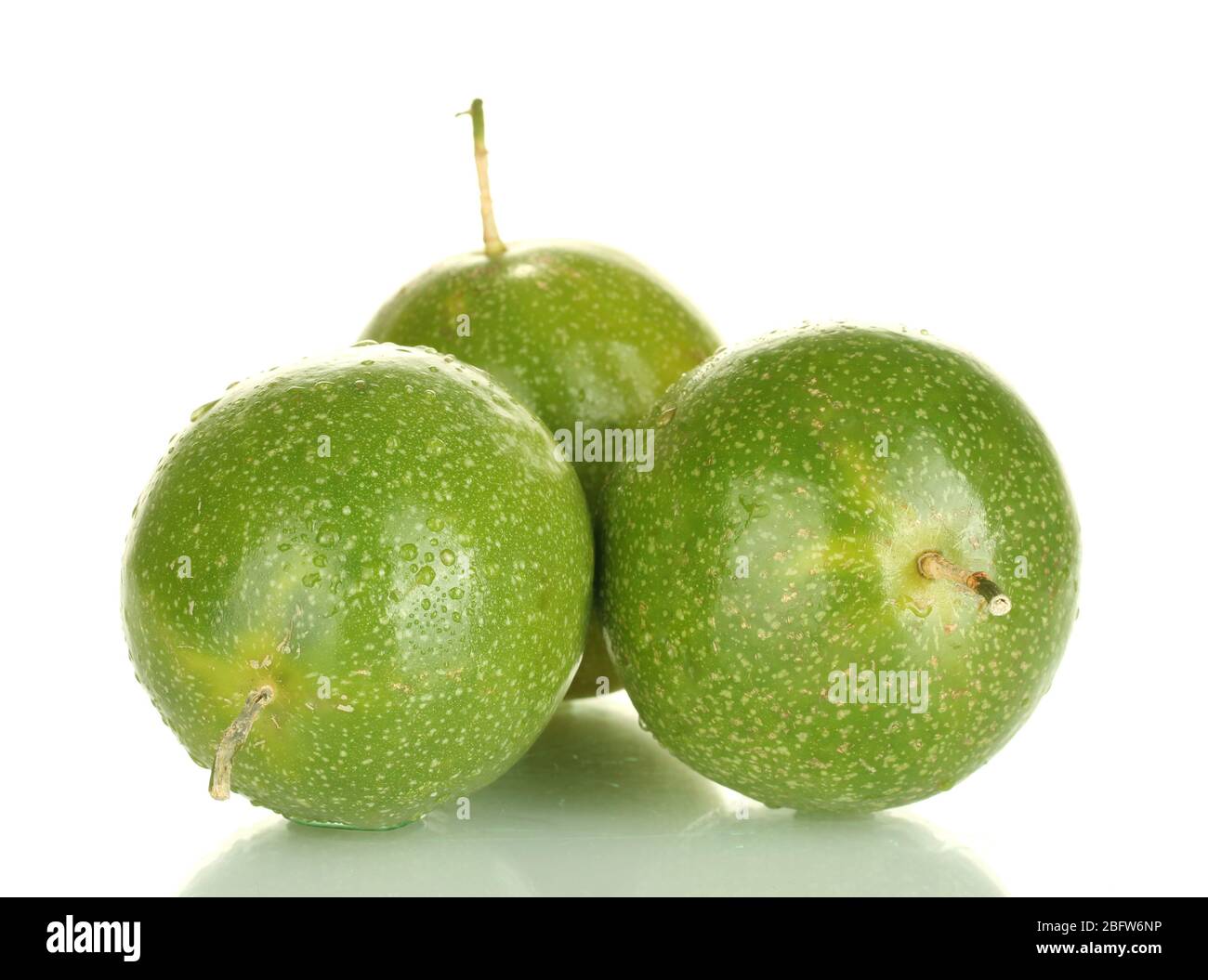 three green passion fruit isolated on white Stock Photo - Alamy