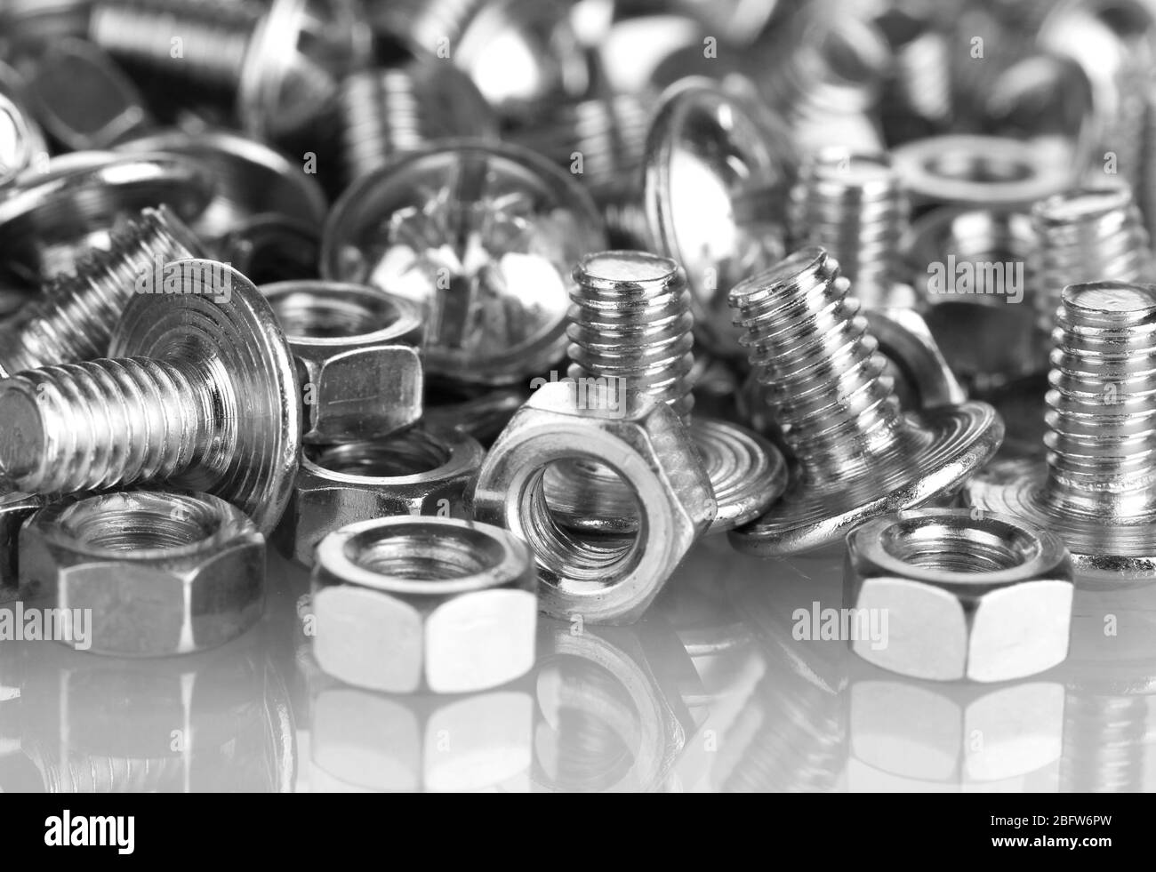 Chrome nuts and bolts on white background close-up Stock Photo - Alamy