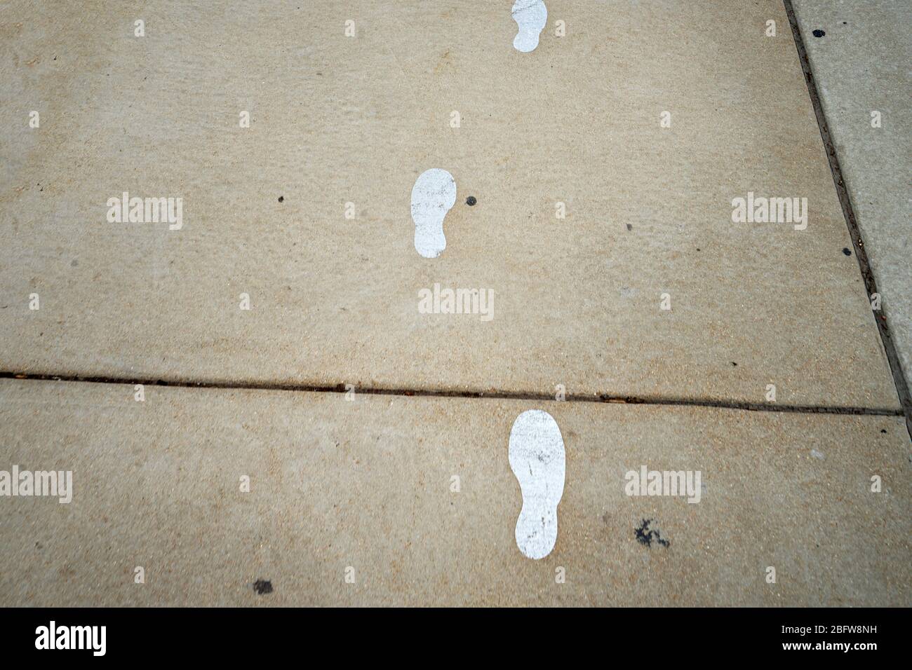 White footprints on cement concrete ground Stock Photo - Alamy
