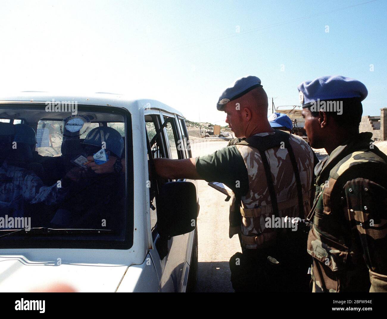 A Belgian soldier performs a security check on a vehicle trying to ...