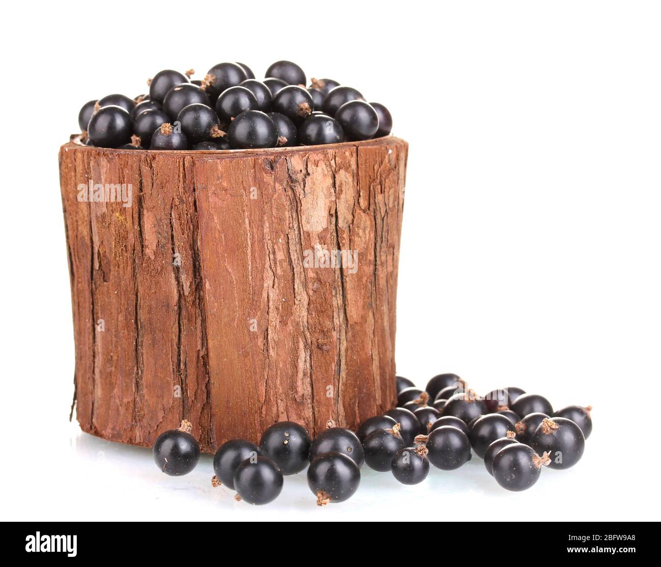 Black currant in wooden cup isolated on white Stock Photo - Alamy