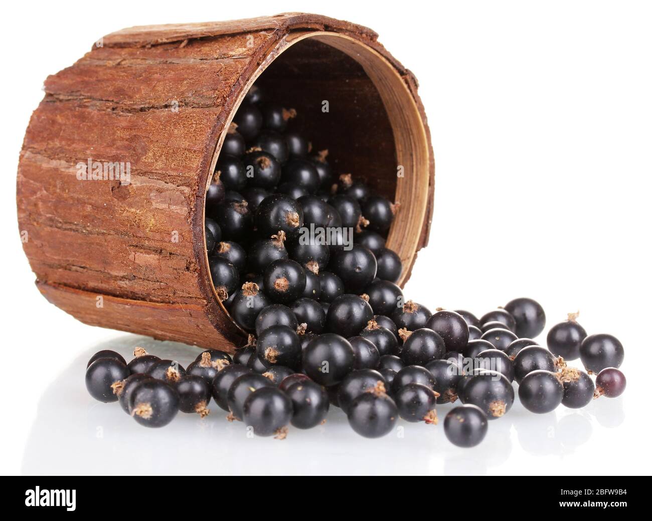 Black currant in wooden cup isolated on white Stock Photo - Alamy