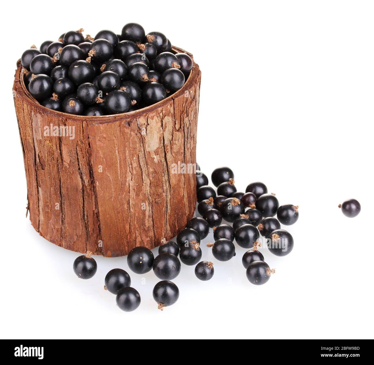 Black currant in wooden cup isolated on white Stock Photo - Alamy