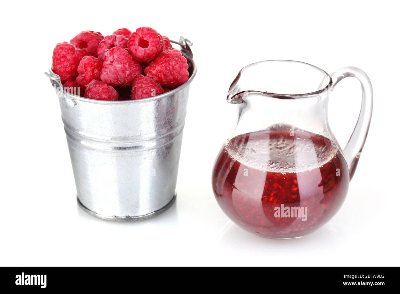 Raspberries in metal bucket and jug with jam isolated on white Stock ...