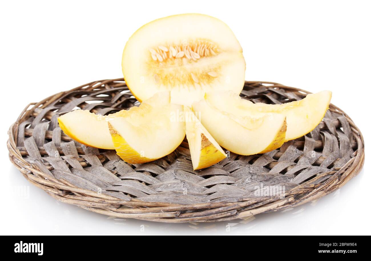 Ripe melon on wicker mat isolated on white Stock Photo - Alamy