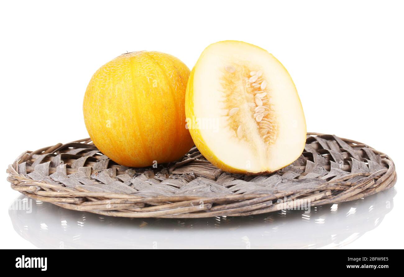 Ripe melon on wicker mat isolated on white Stock Photo - Alamy