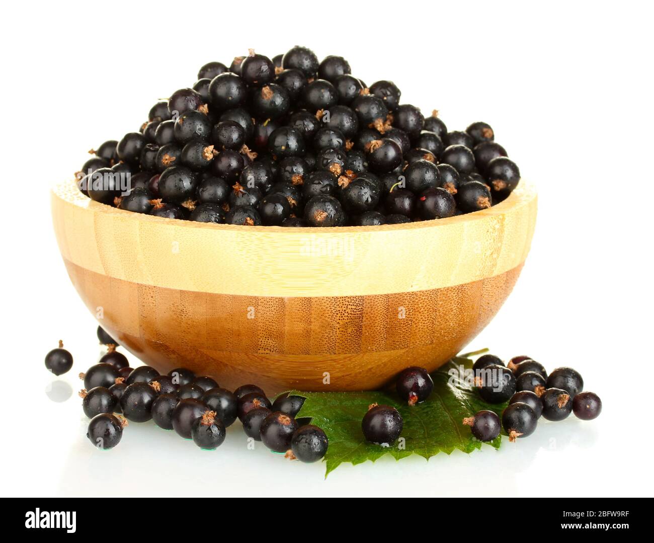 Fresh black currant in wooden bowl isolated on white Stock Photo - Alamy
