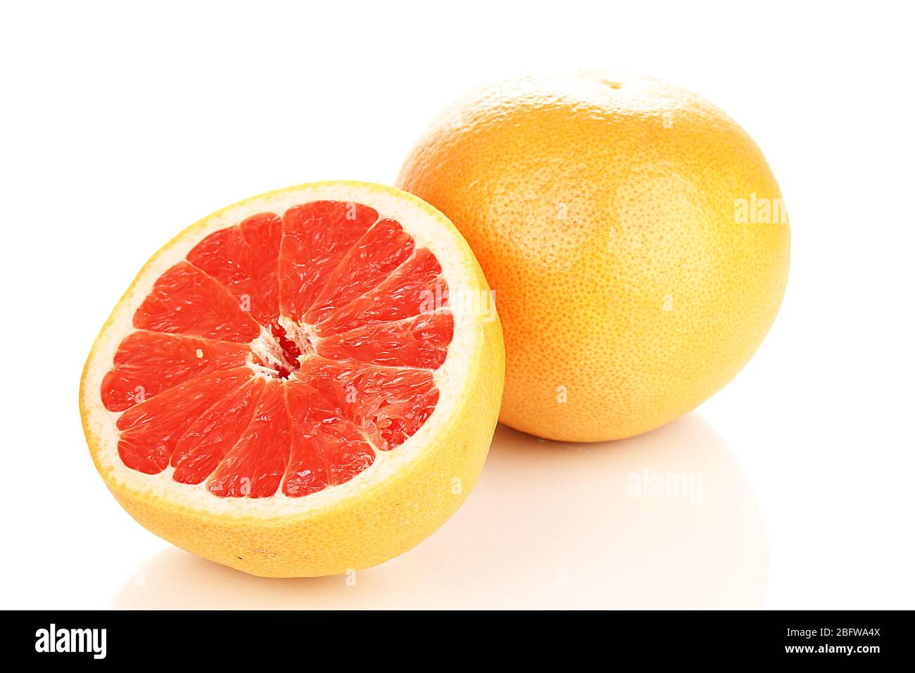 Ripe grapefruit and half isolated on white Stock Photo - Alamy