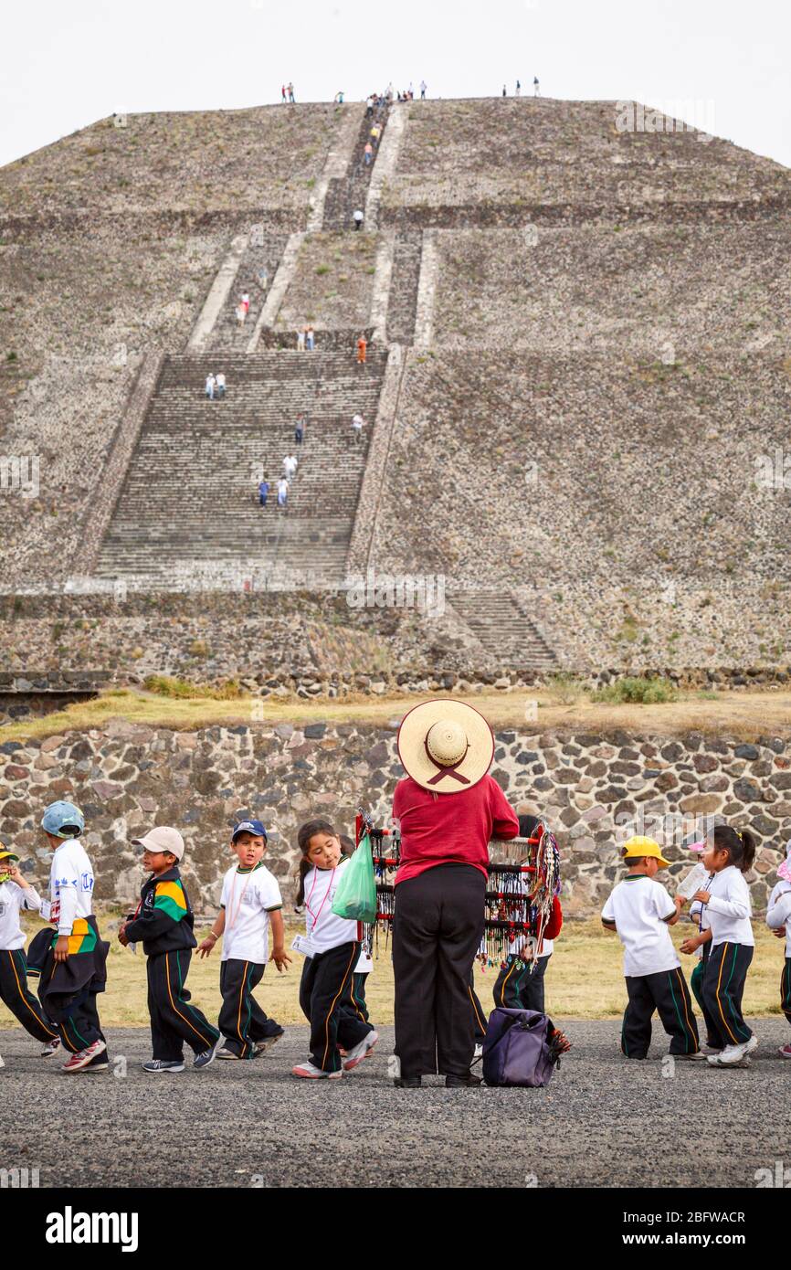 School children look at a vendors items near the Pyramid of the Sun at ...