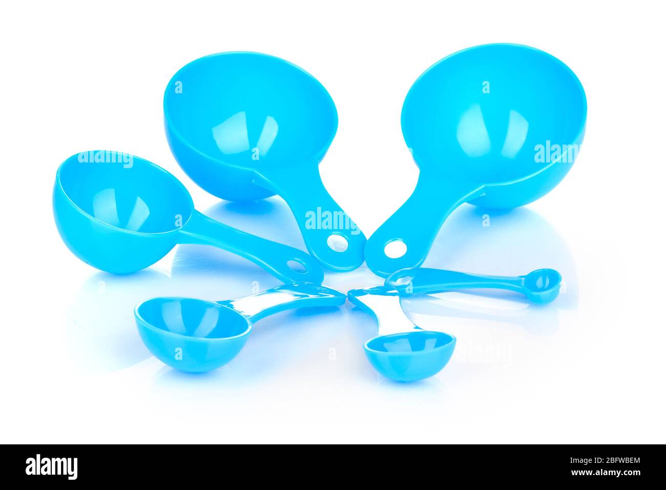 Blue measuring spoons isolated on white Stock Photo - Alamy