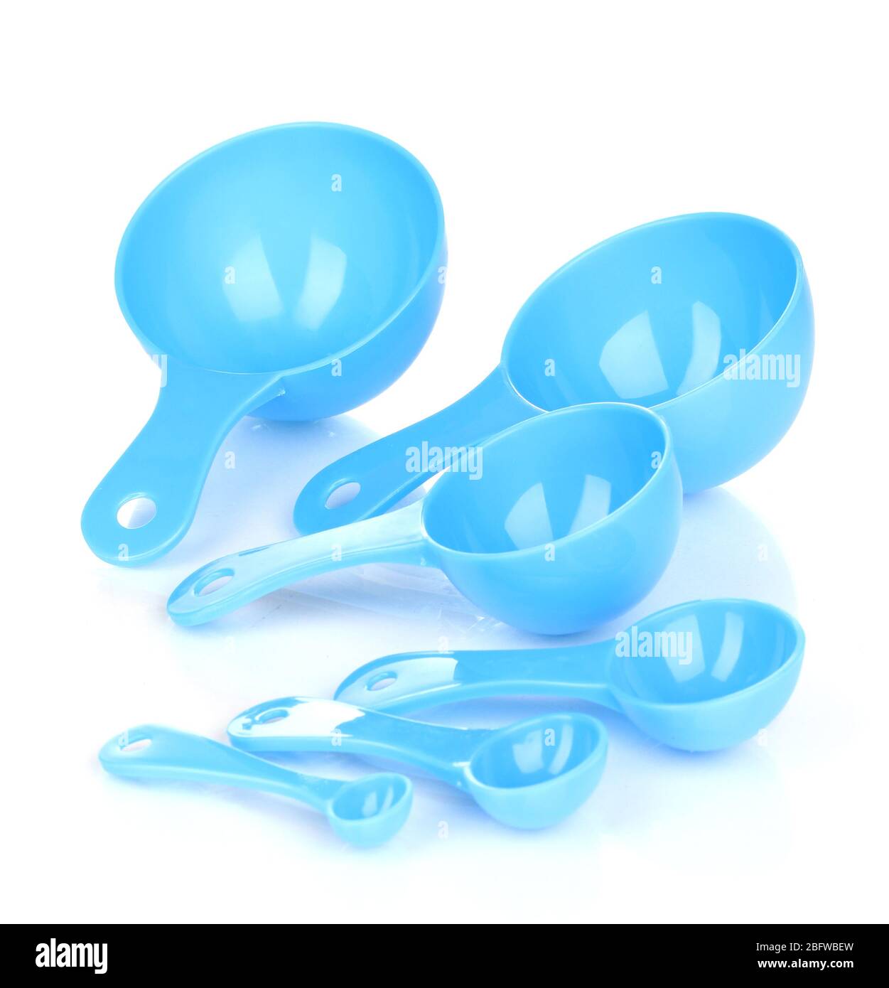 Blue measuring spoons isolated on white Stock Photo - Alamy