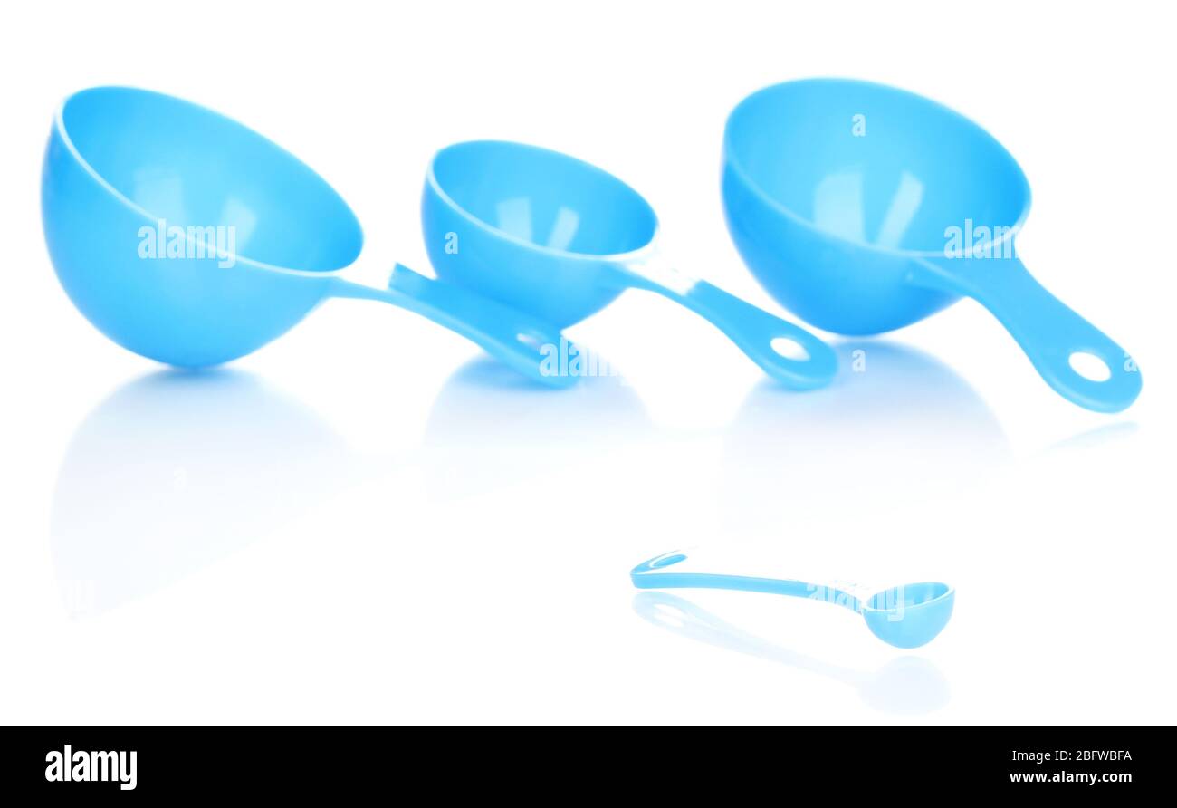 Blue measuring spoons isolated on white Stock Photo - Alamy