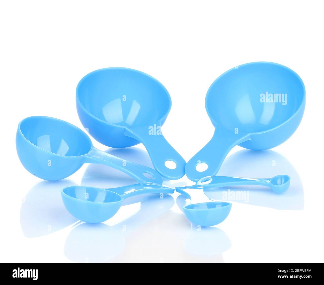 Blue measuring spoons isolated on white Stock Photo - Alamy