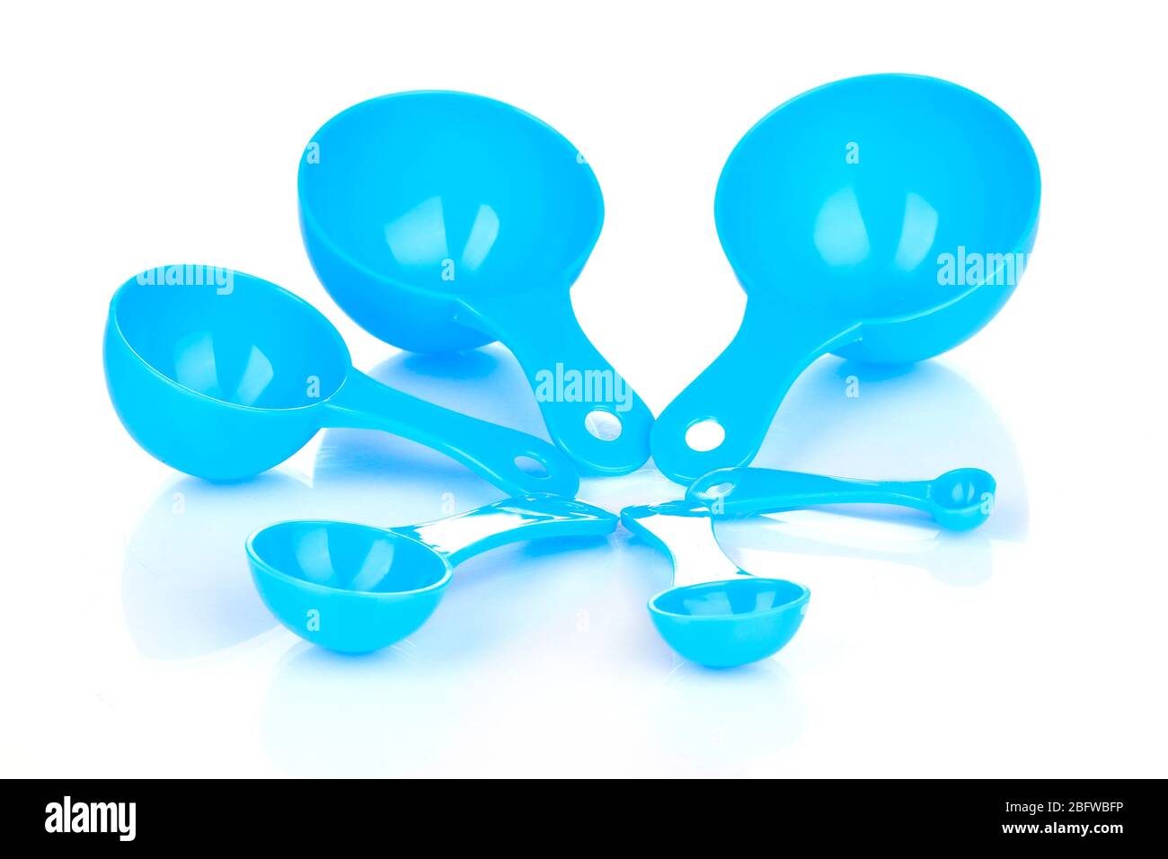 Blue measuring spoons isolated on white Stock Photo - Alamy