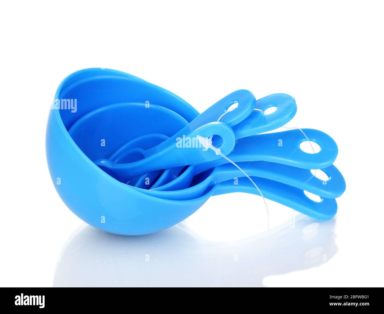Blue measuring spoons isolated on white Stock Photo - Alamy