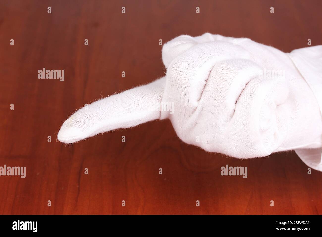 Female hand checking cleanliness on wooden background Stock Photo - Alamy