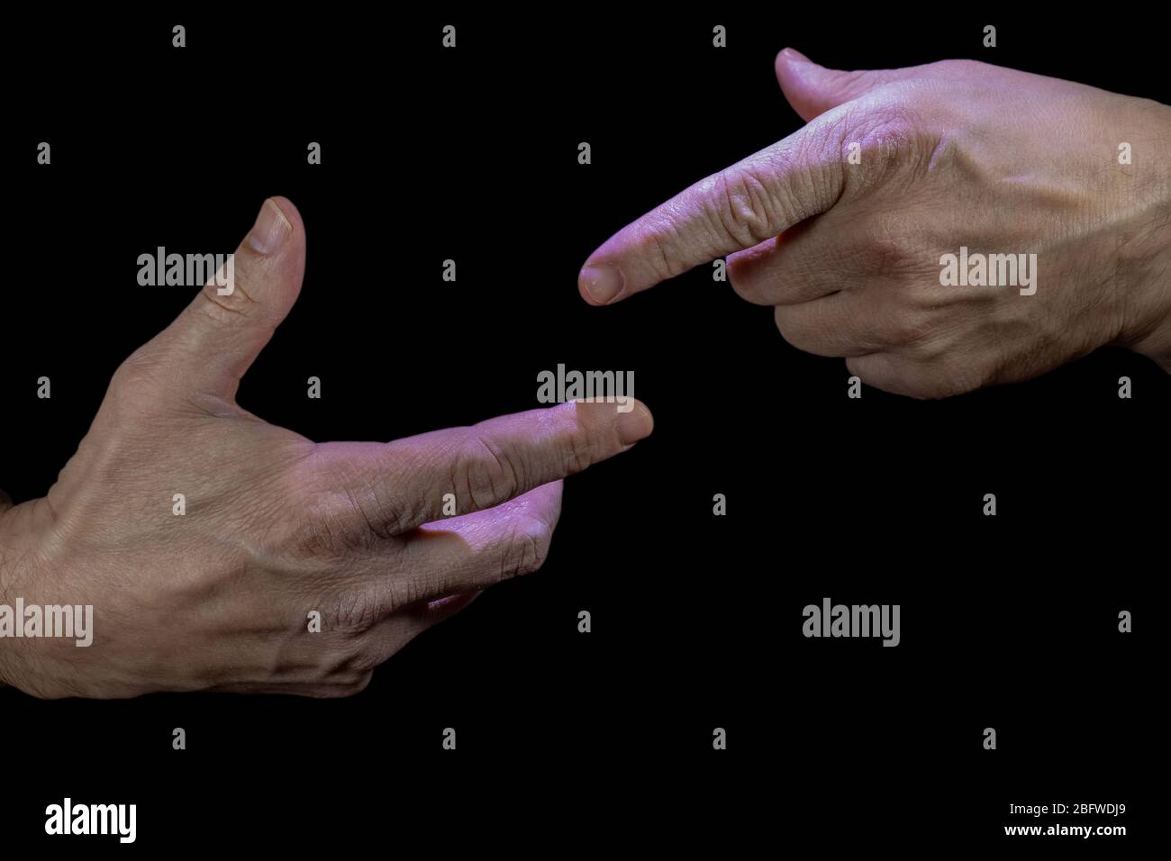 Human hand with pointed fingers on black background Stock Photo - Alamy