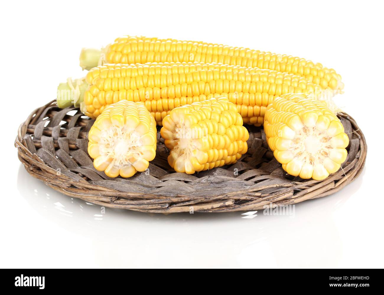 Fresh corn on wicker mat isolated on white Stock Photo - Alamy