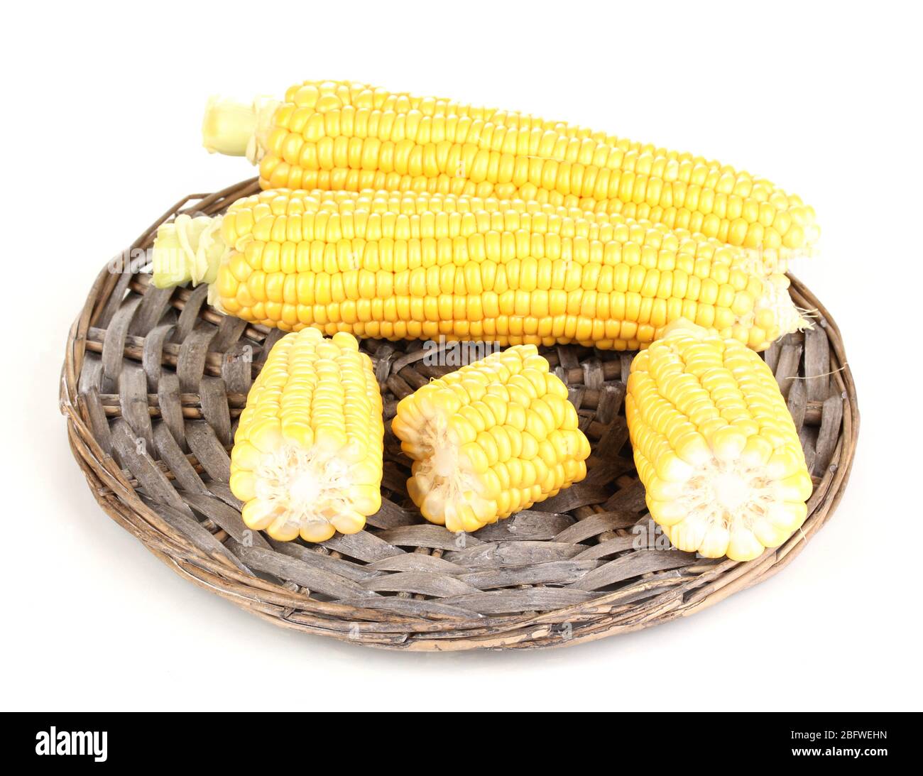 Fresh corn on wicker mat isolated on white Stock Photo - Alamy