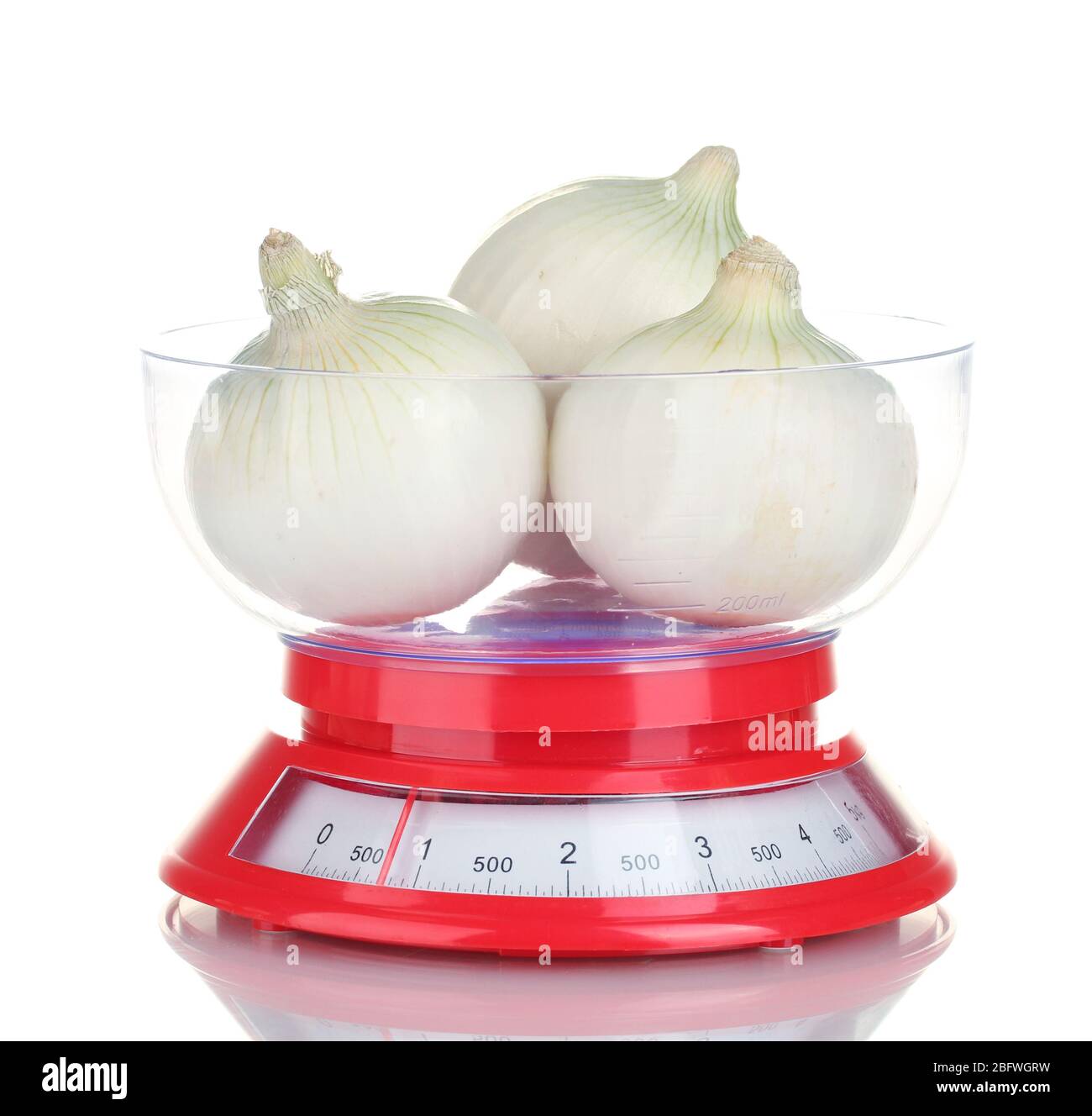 white onion n a kitchen scales isolated on white background Stock Photo ...