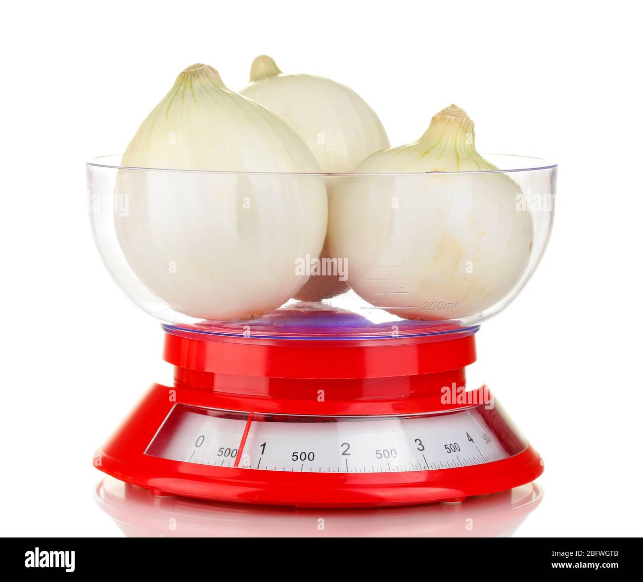 white onion n a kitchen scales isolated on white background Stock Photo ...