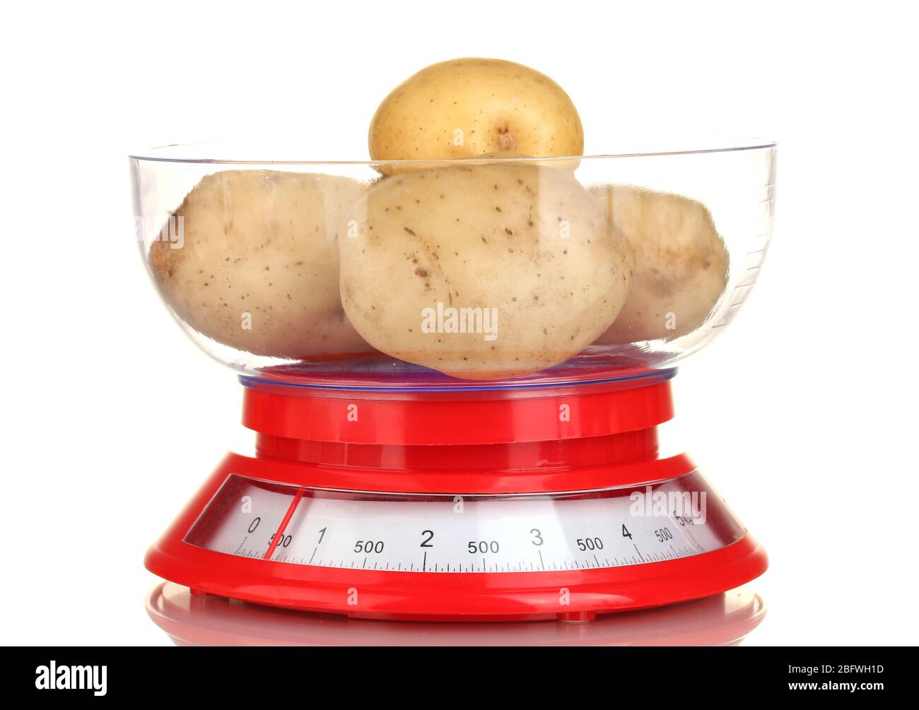 fresh potatoes in a kitchen scales isolated on white Stock Photo - Alamy