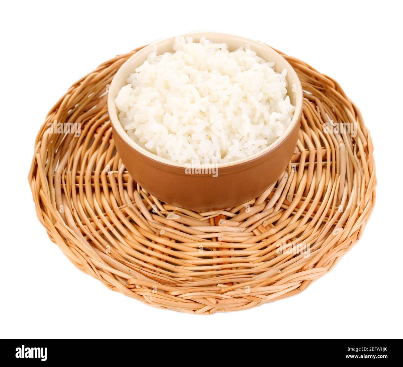 Bowl of rice on wicker mat isoalted on white Stock Photo - Alamy
