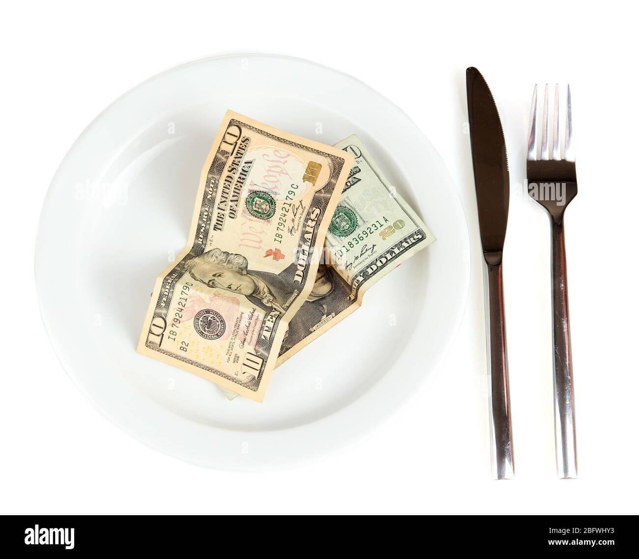 Money on plate isolated on white background close-up Stock Photo - Alamy