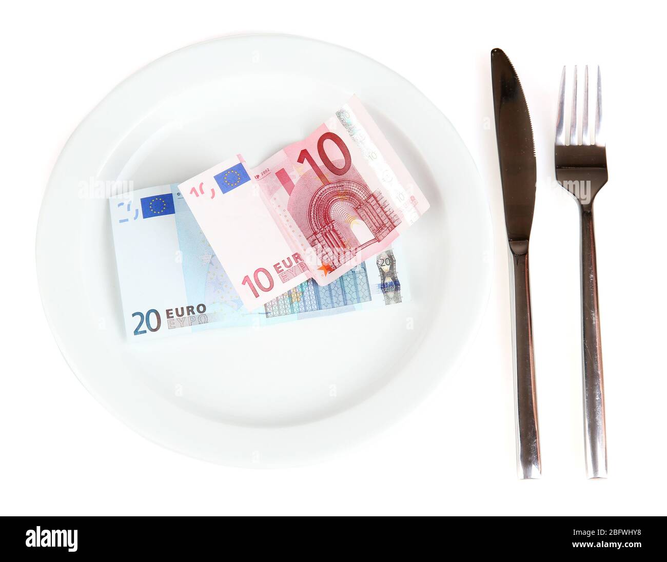 Money on plate isolated on white background close-up Stock Photo - Alamy