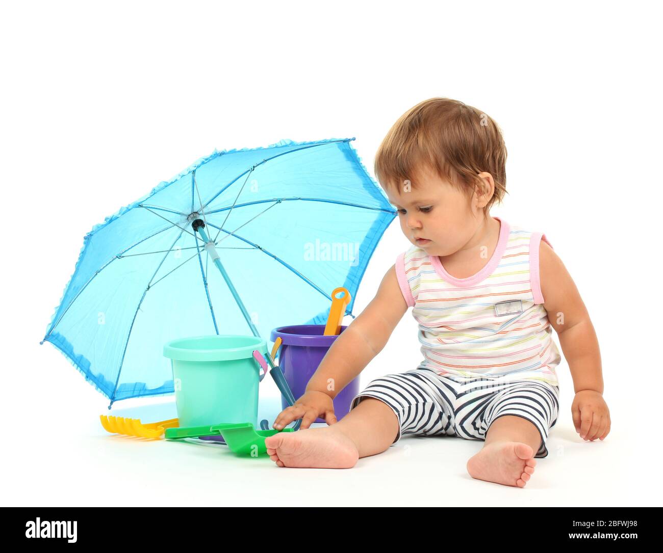 Cute baby with bucket and spade near umbrella isolated on white Stock ...