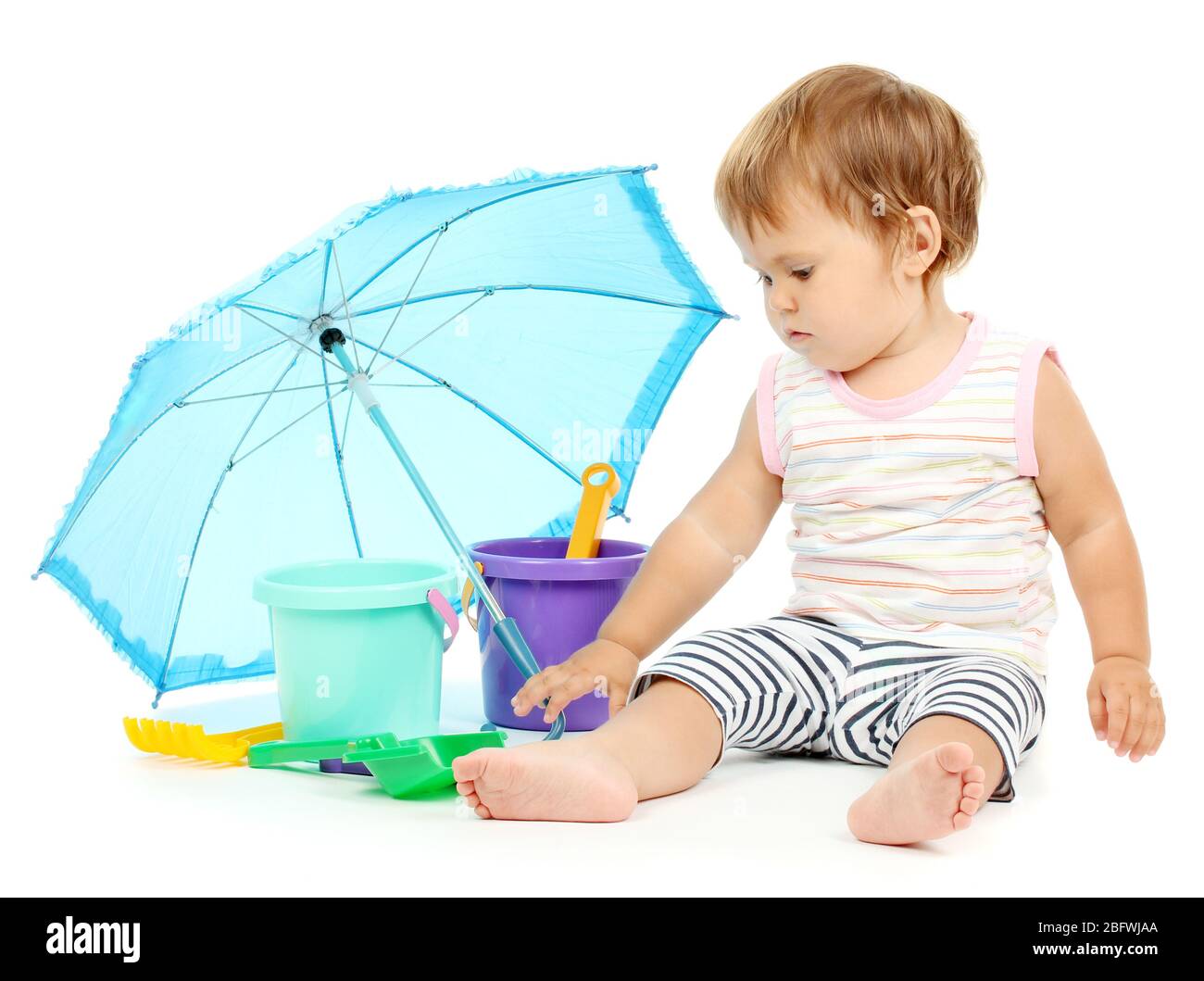 Cute baby with bucket and spade near umbrella isolated on white Stock ...