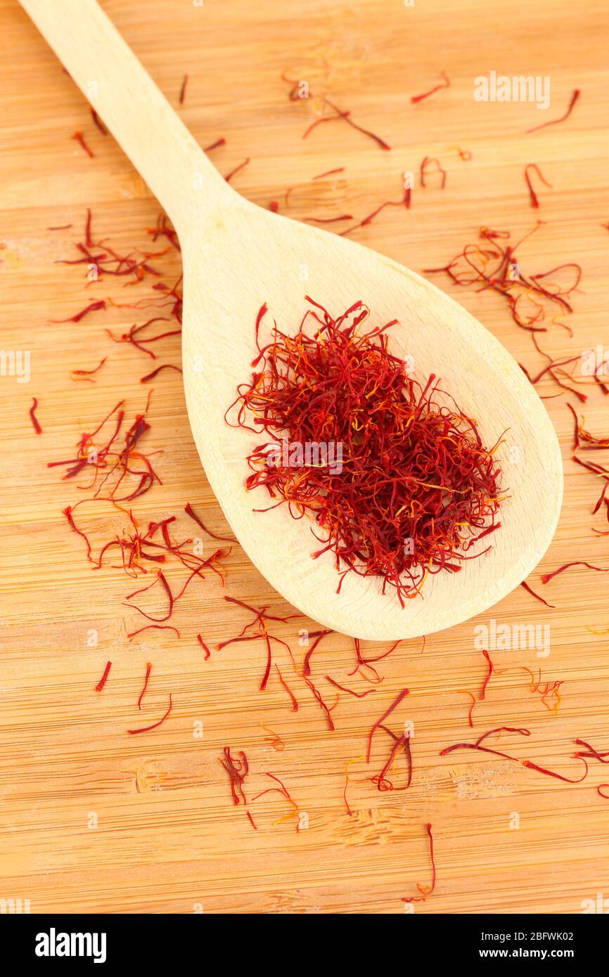 stigmas of saffron in wooden spoon on wooden background close-up Stock ...
