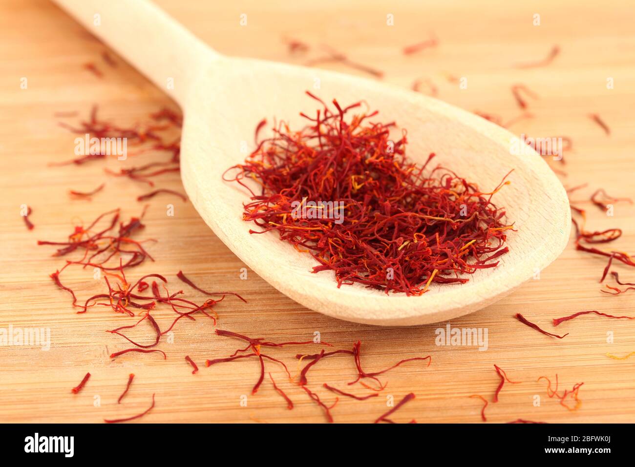 stigmas of saffron in wooden spoon on wooden background close-up Stock ...