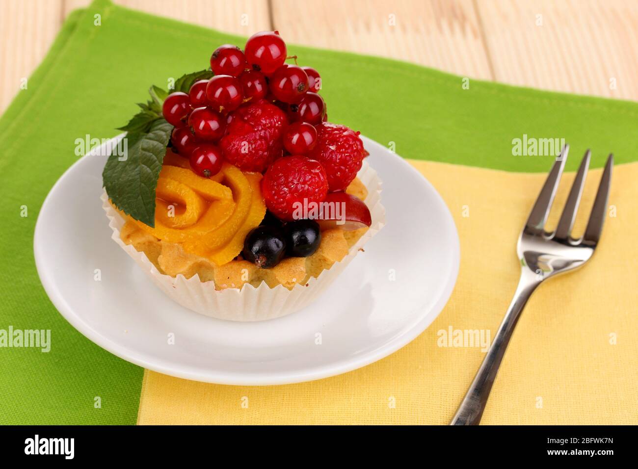 Dulcet cake with fruit and berries on wooden table Stock Photo - Alamy