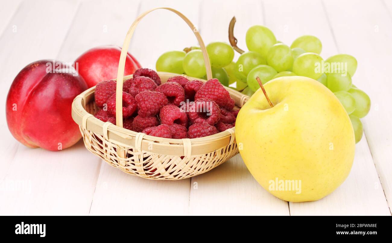 ripe sweet fruits and berries on wooden background Stock Photo - Alamy