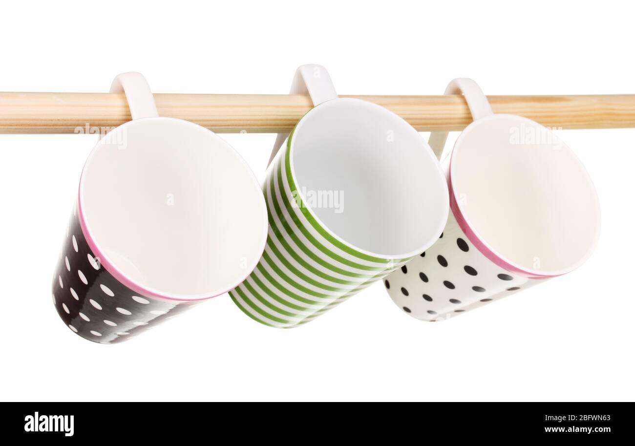 Nice cups hanging on stick isolated on white Stock Photo - Alamy
