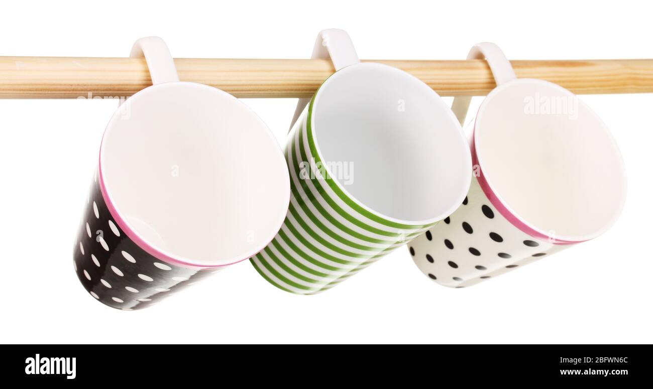 Nice cups hanging on stick isolated on white Stock Photo - Alamy