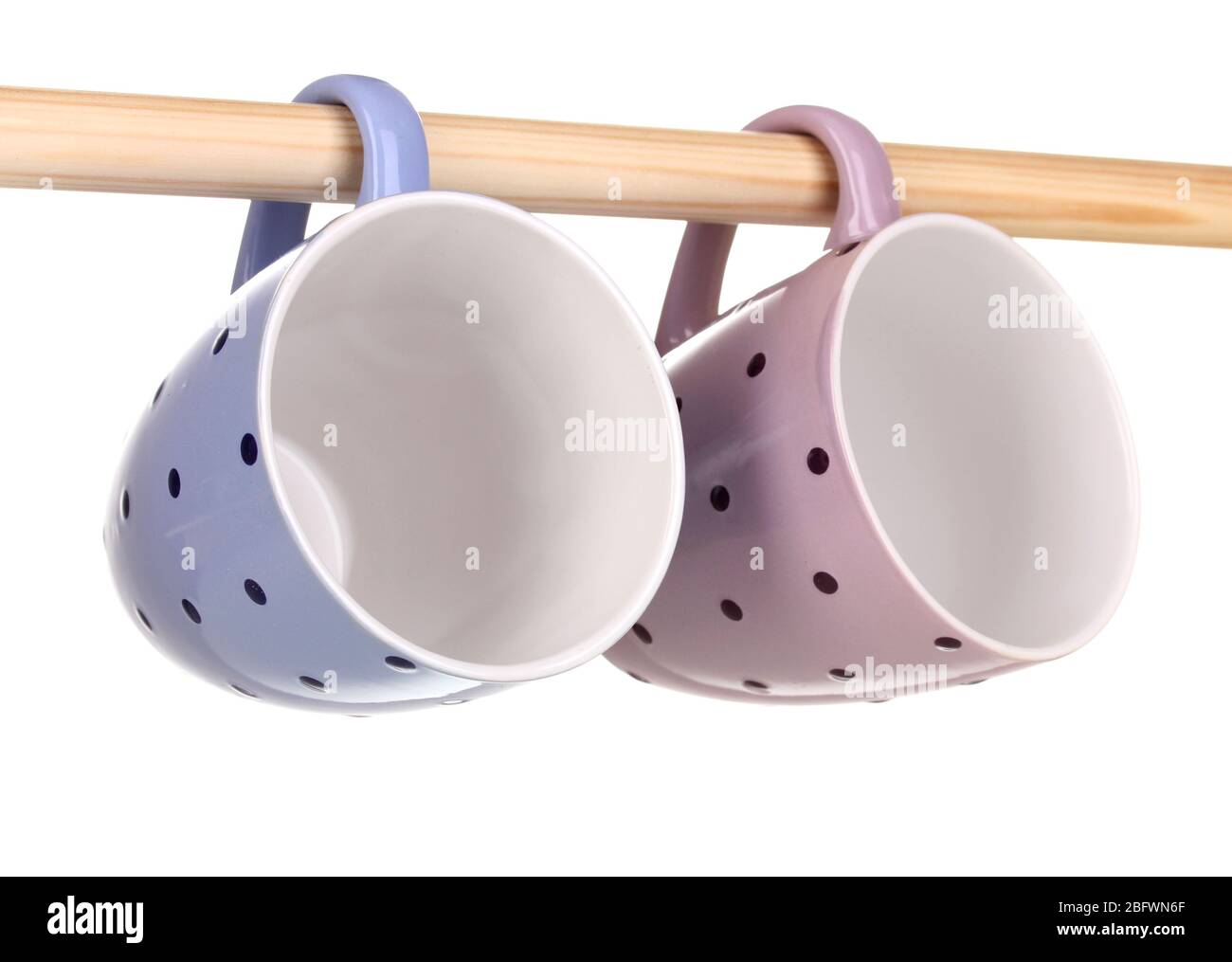 Nice cups hanging on stick isolated on white Stock Photo - Alamy