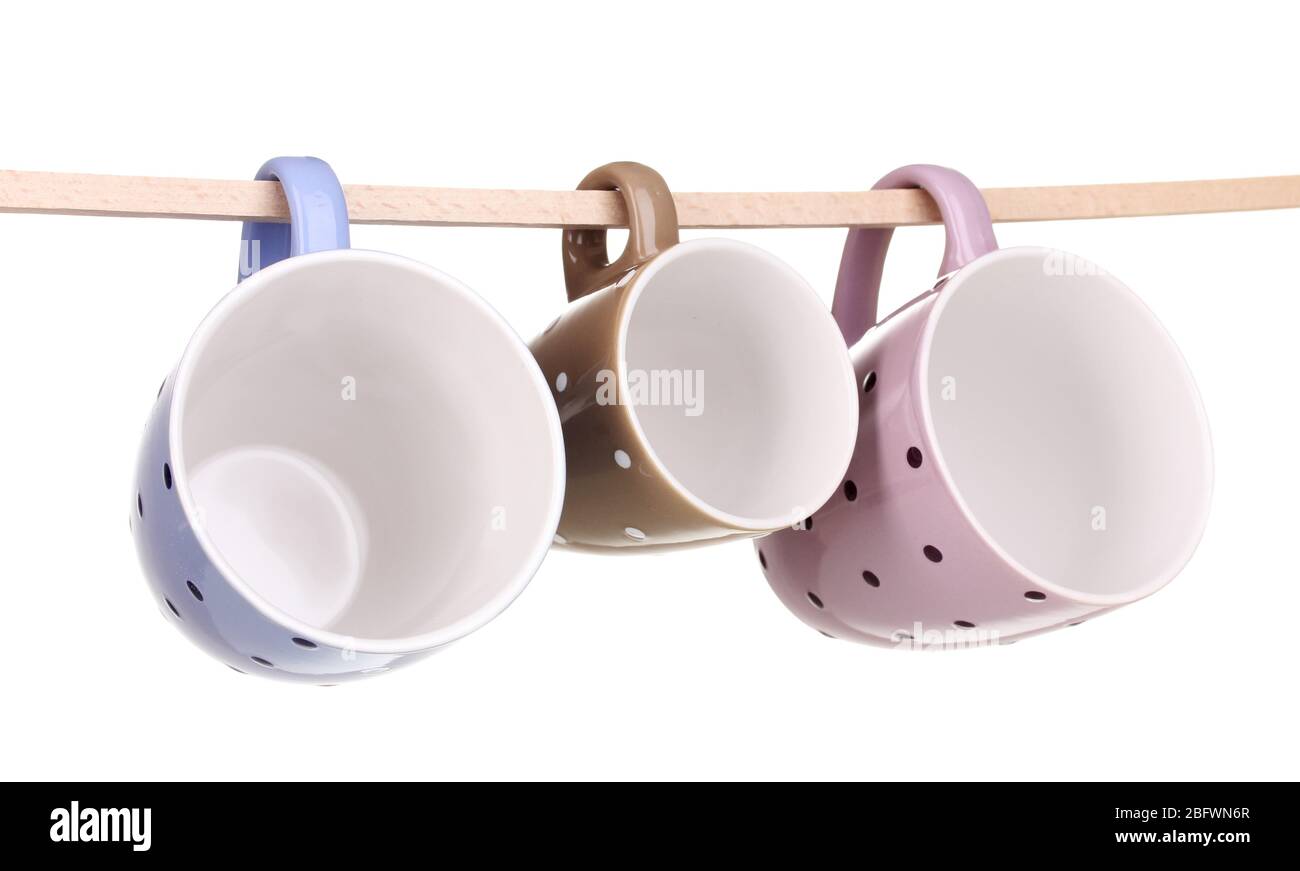 Nice cups hanging on stick isolated on white Stock Photo - Alamy