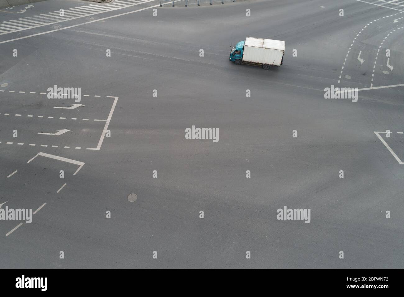 Aerial view of single car driving on intersection Stock Photo - Alamy