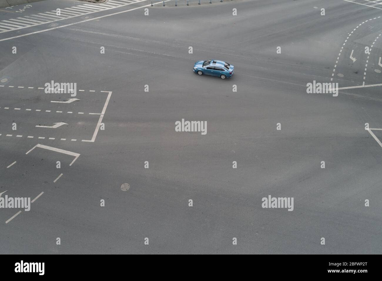 Aerial view of single car driving on intersection Stock Photo - Alamy