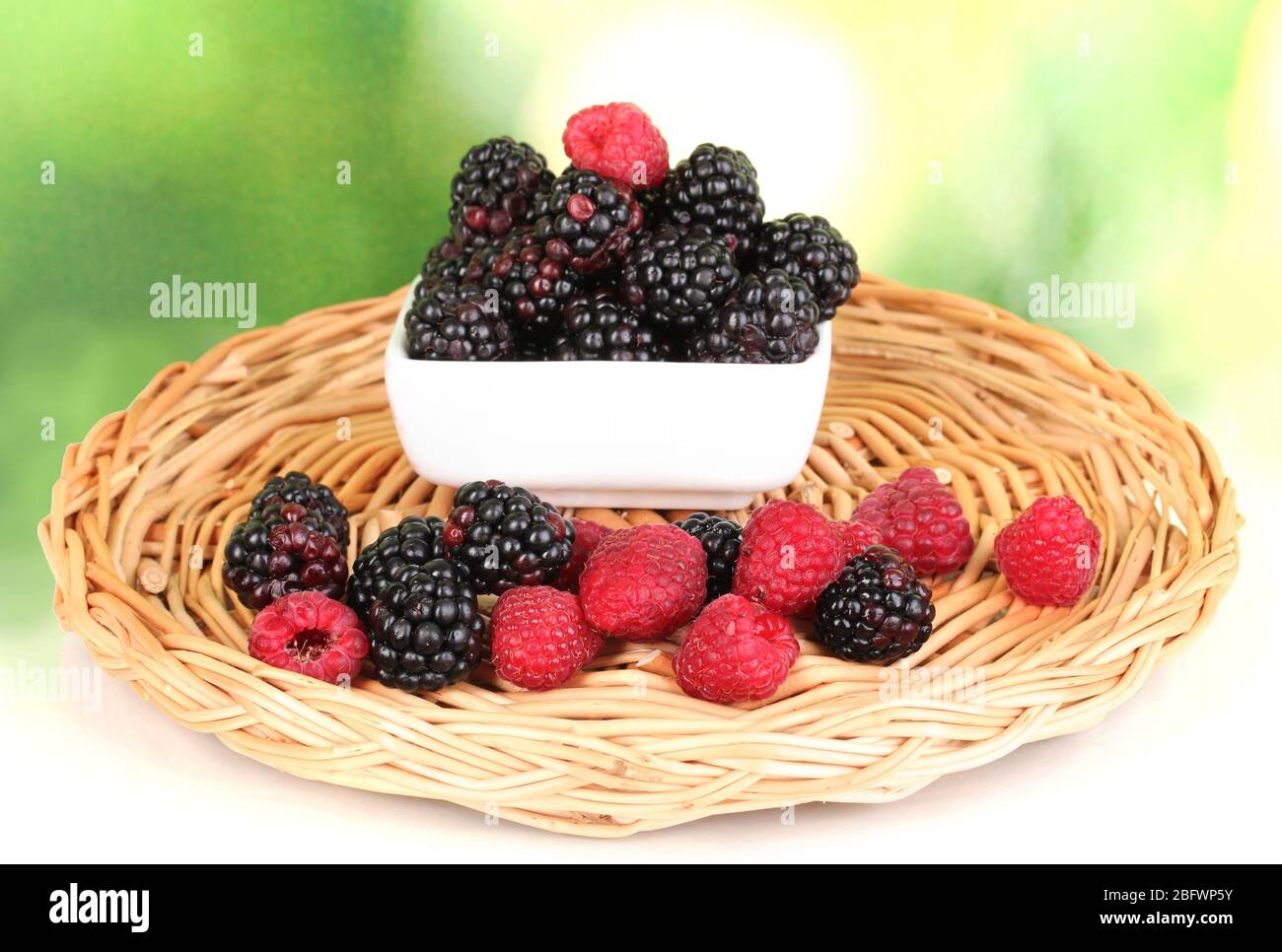 Ripe raspberries and brambles on nature background Stock Photo - Alamy